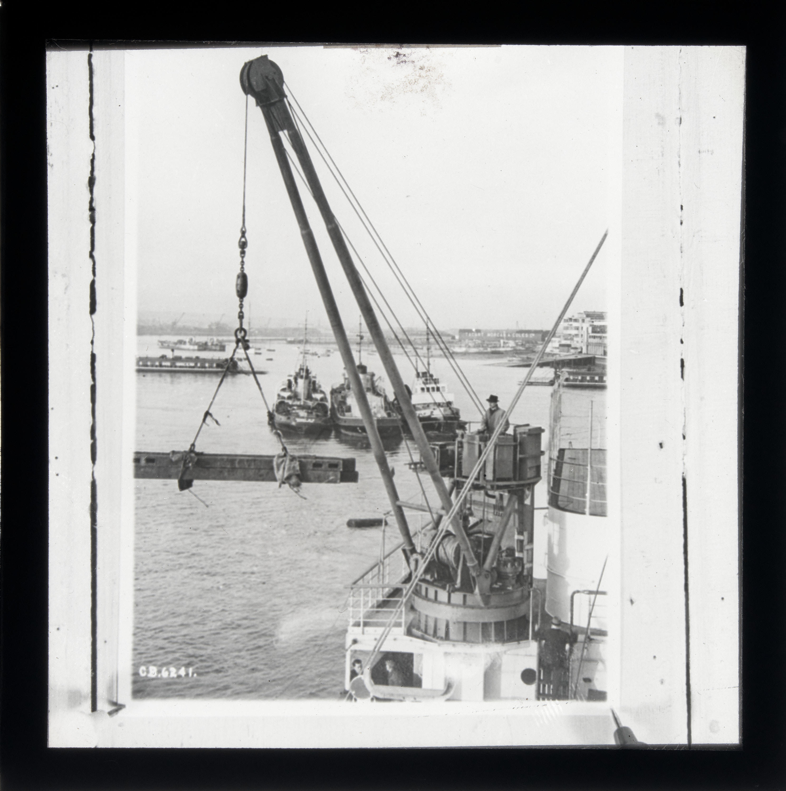 Lantern slide: Image of a crane with luffing system hoisting timber ...