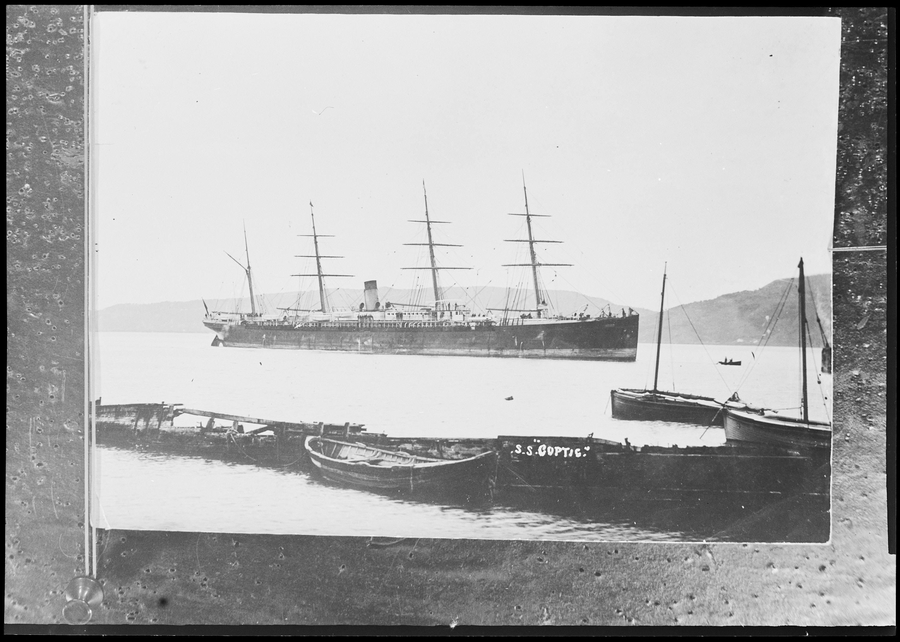 Medium format film negative: SS COPTIC (181) near port with a wrecked ...