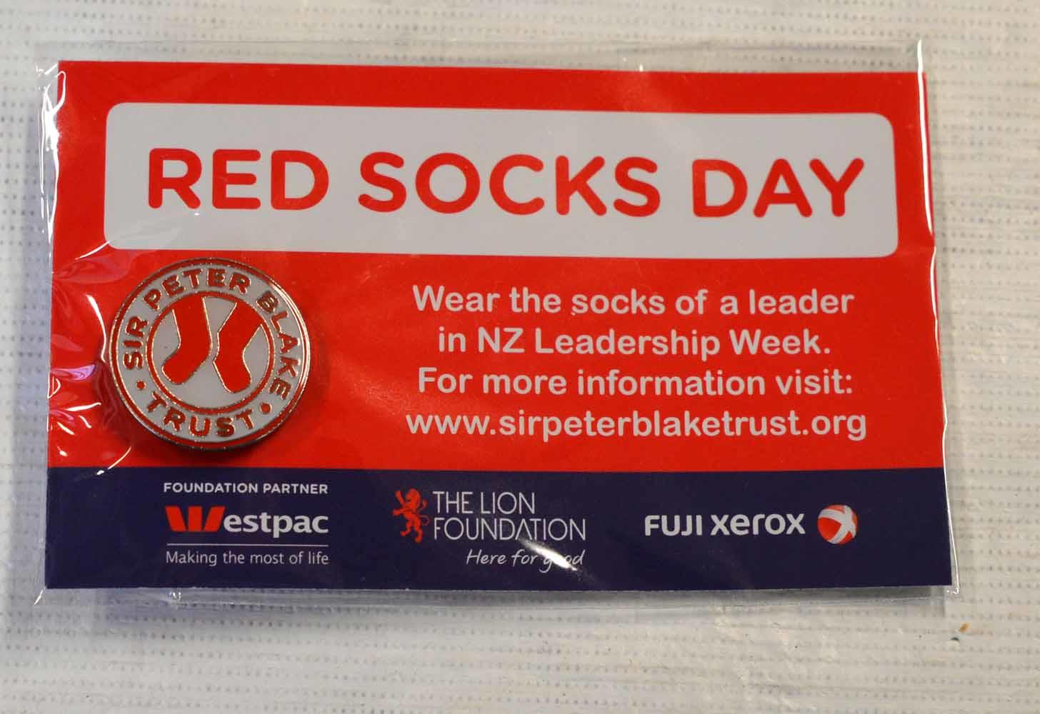 Badge: Red Socks Day/ Sir Peter Blake Trust - New Zealand Maritime Museum