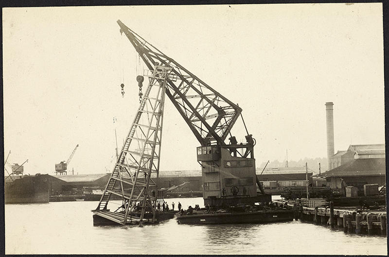 Photograph: Floating crane lifting new pile driver frame onto its punt ...