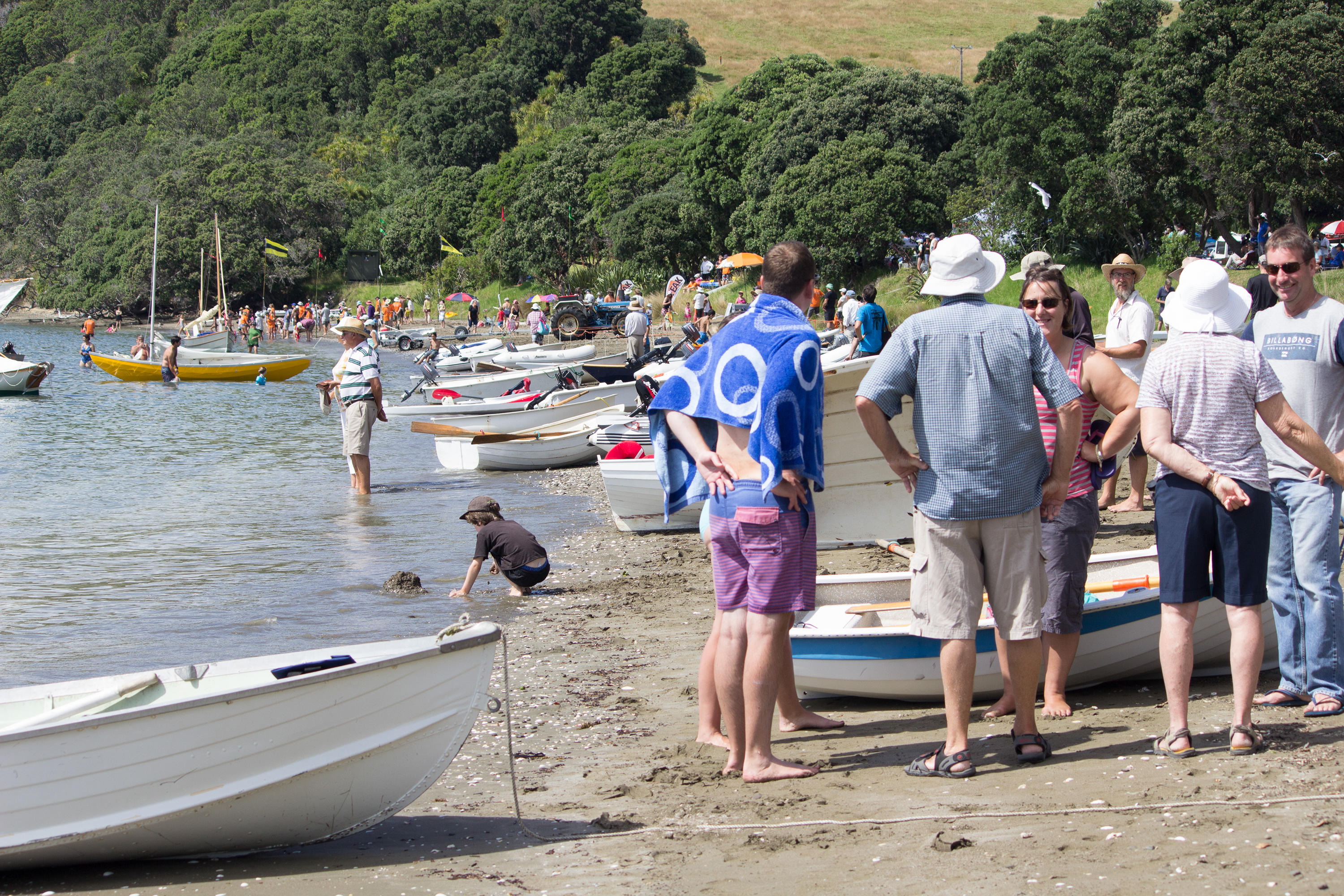 Photograph: People and dinghies on beach, Sullivan's Bay, Mahurangi ...