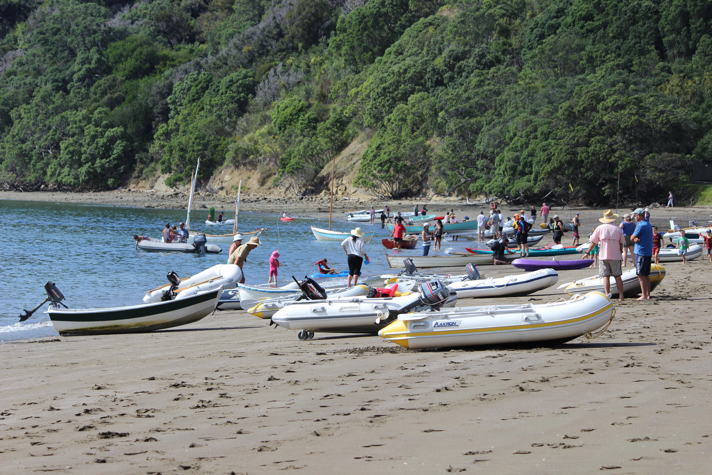 Photograph: People, dinghies and outboard boats on beach, Sullivan's ...