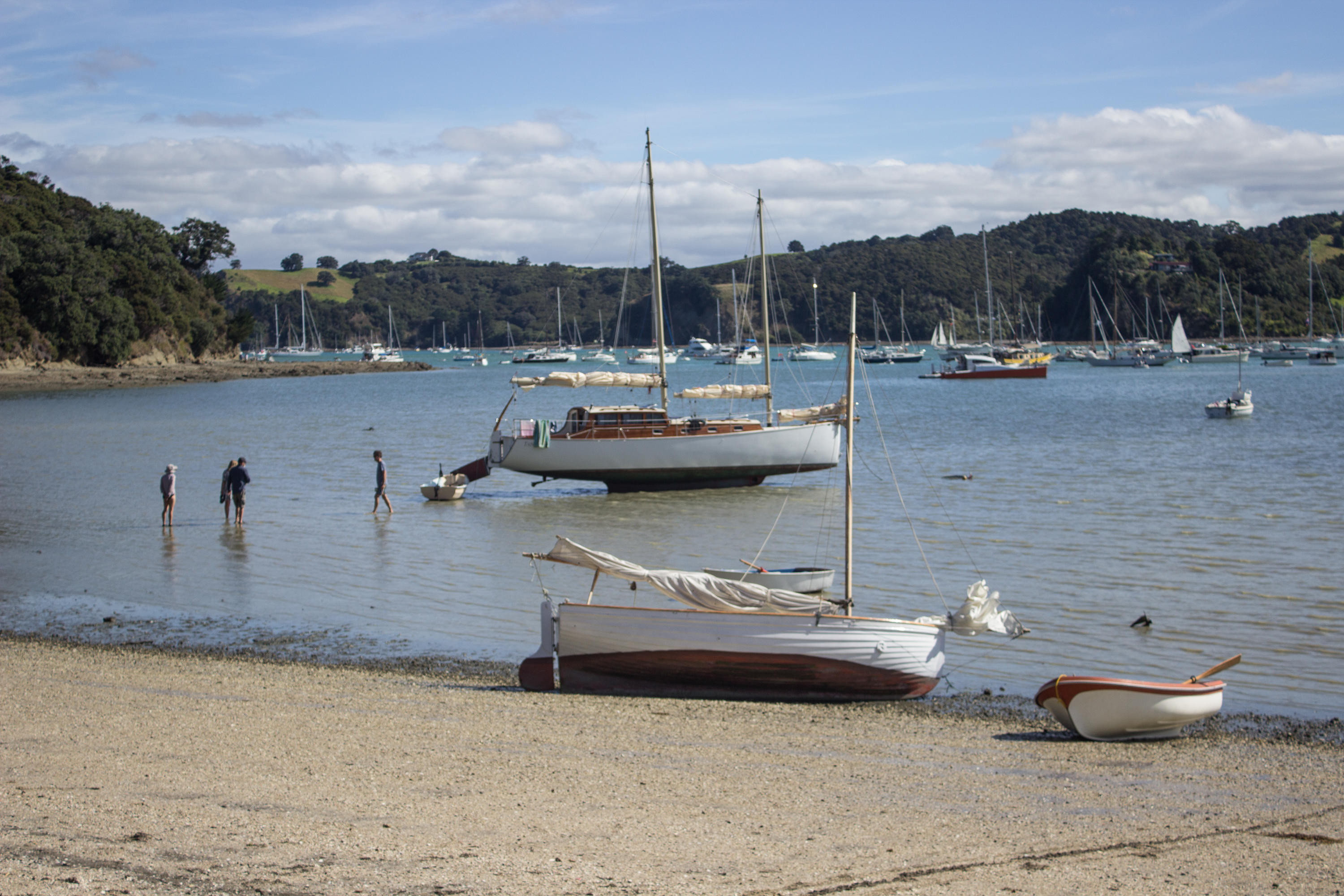 Photograph: Yacht, clinker boat and dinghy on beach, Mahurangi Harbour ...