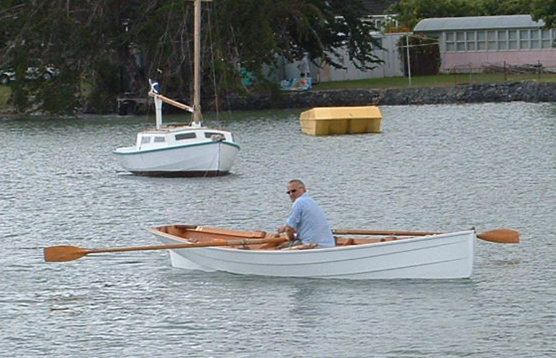 Photograph: A person in a rowing skiff on the Hauraki Gulf - New ...