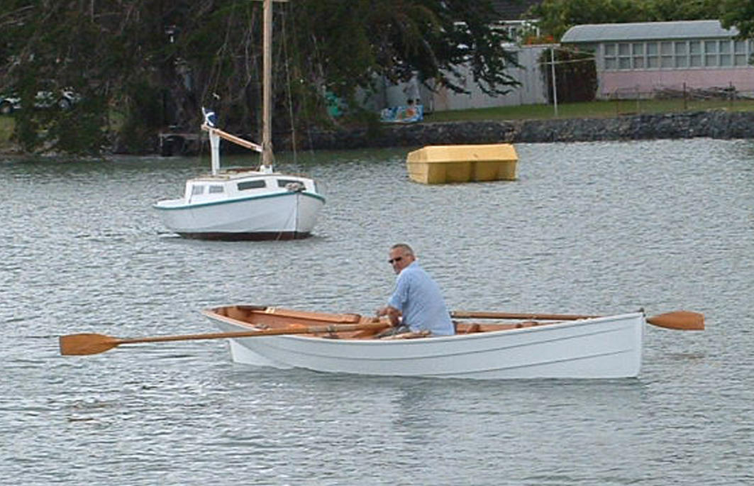 Photograph: A person in a rowing skiff on the Hauraki Gulf - New ...
