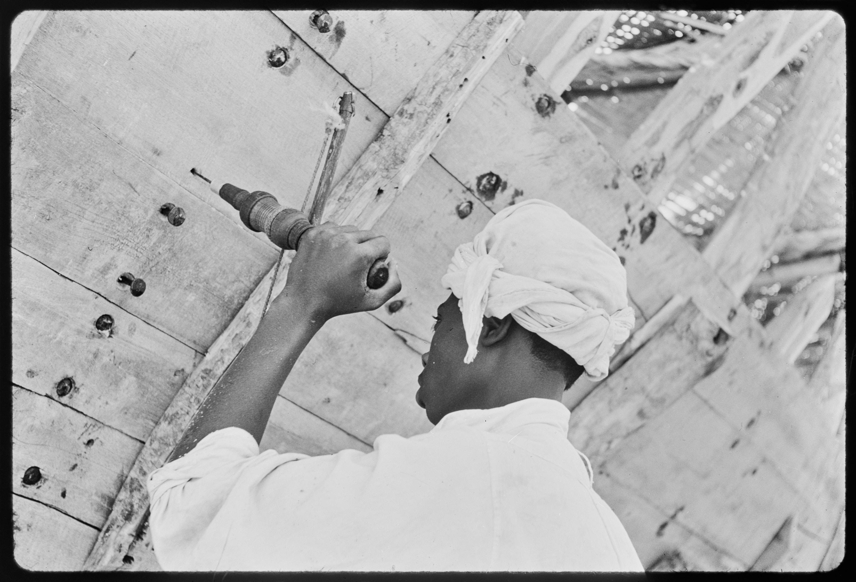 Negative: Shipwright using bow drill, Kuwait, 1967 - New Zealand ...