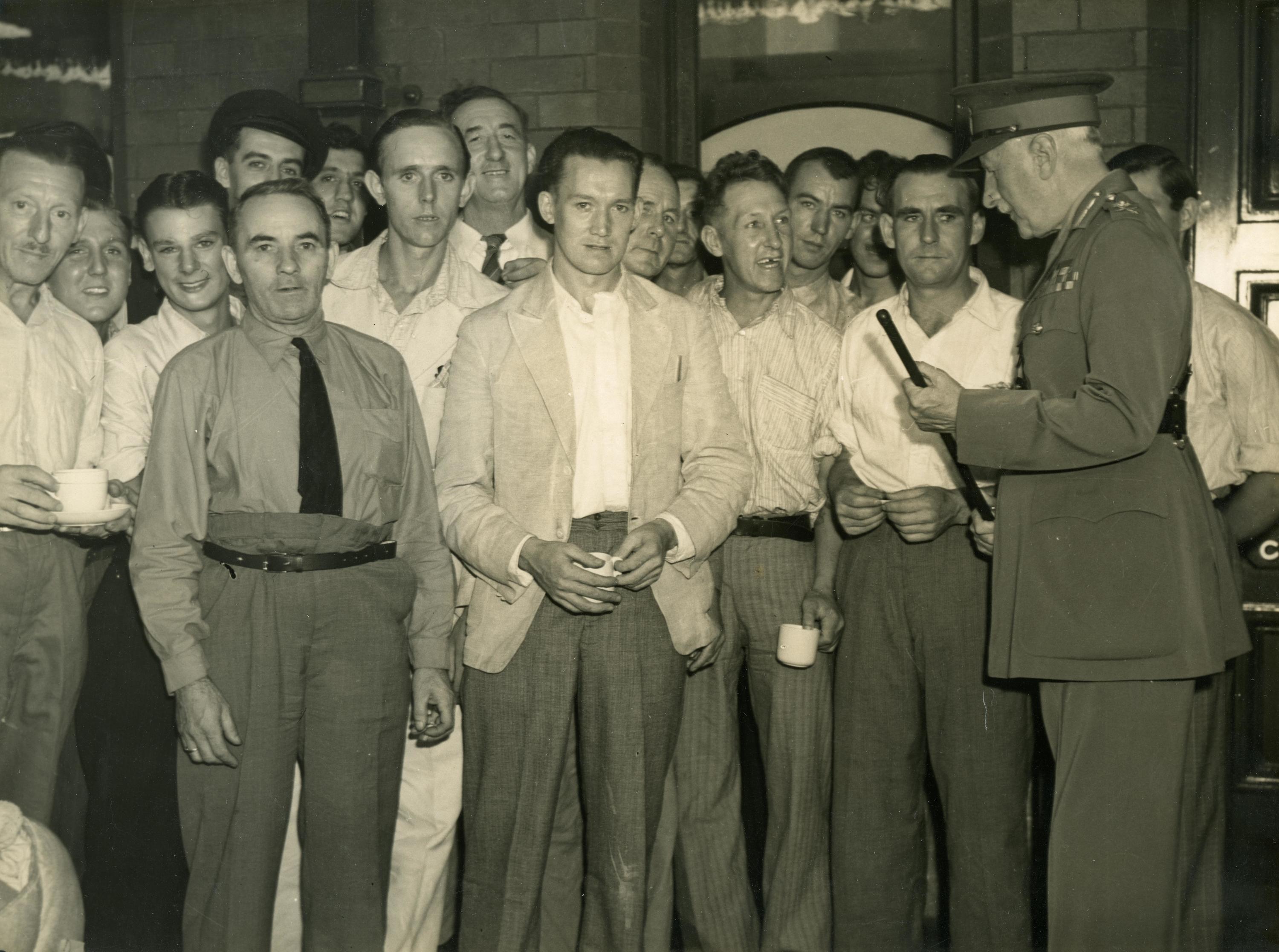 Photograph: Lord Gowrie speaking to survivors from the sinking of ...