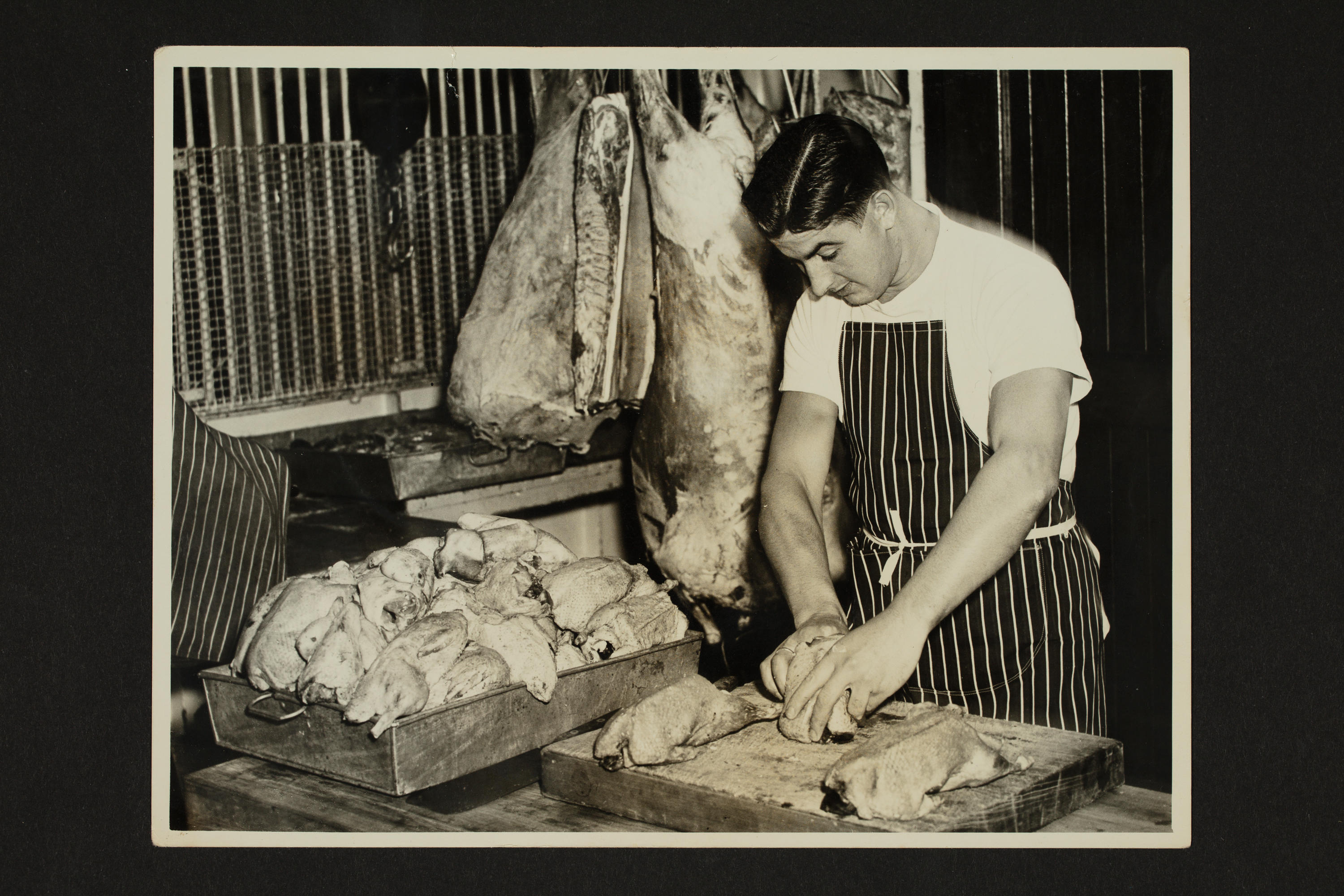 Photograph: Butcher onboard a vessel[?] - New Zealand Maritime Museum